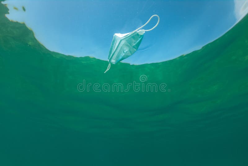 Face mask in ocean stock image. Image of pandemic, used - 229794323