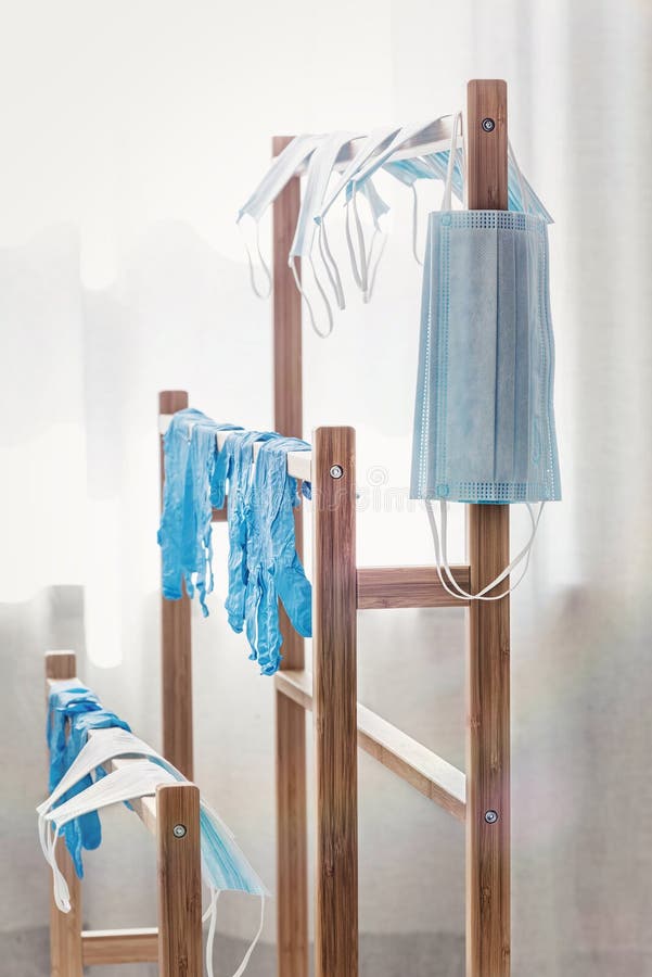 Face Masks and Gloves Hanging on a Rack Stock Photo - Image of ...
