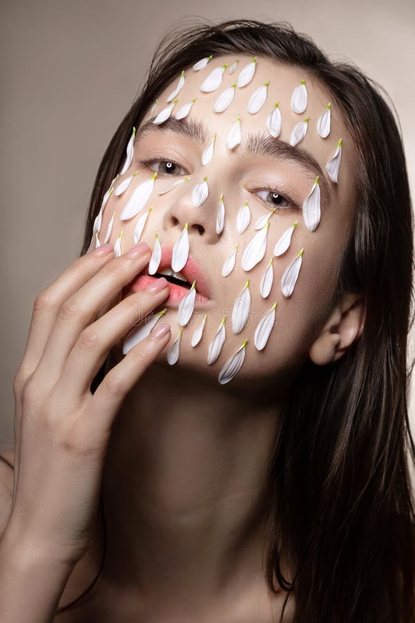 Model with Thick Dark Eyebrows Posing with Petals on Face Stock Image ...