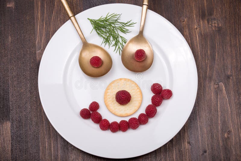 Face on a Plate of Raspberries Stock Photo - Image of nutrition, design ...