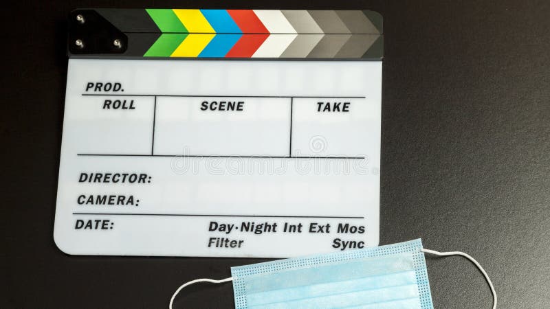Face Protection Mask with Clapper Board on the Table on Black ...