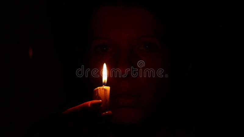 The Face of a Ukrainian Girl in the Dark with a Candle, a Candle Flame ...