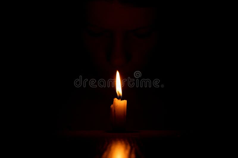 The Face of a Ukrainian Girl in the Dark with a Candle, a Candle Flame ...