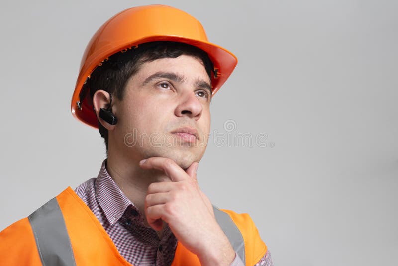 Young Engineer Architect in Hard Hat and Reflective Vest Thinking with ...