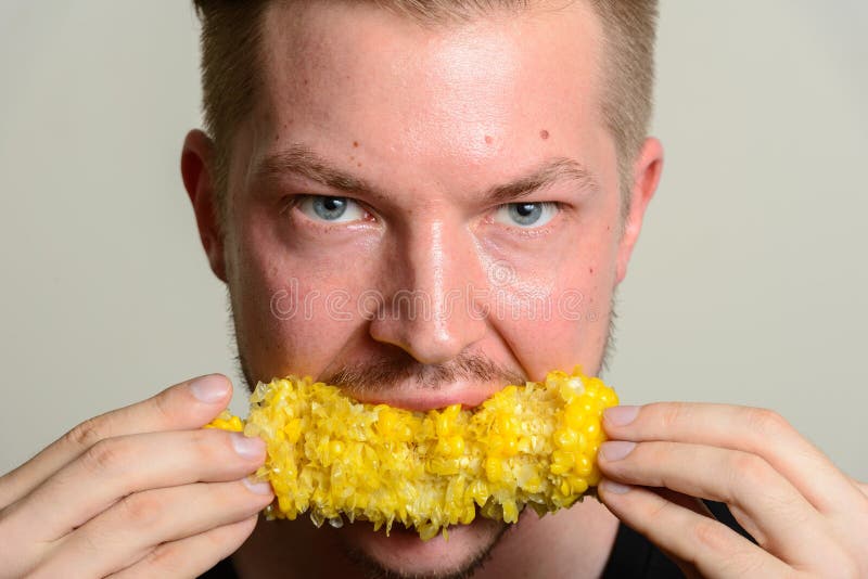 Face of Young Handsome Man Eating Corn Cob Stock Photo - Image of ...