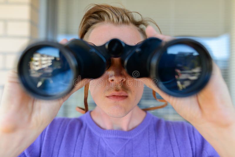 Face of Young Handsome Man Looking through Binoculars Stock Photo ...