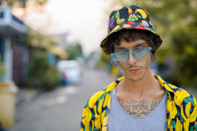 Face of Young Rebellious Man Thinking while Looking Down Outdoors Stock ...