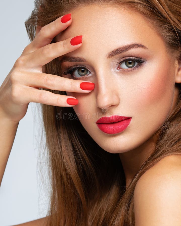 Face Of Young Woman With Red Nails Lipstick And Long Brown Hair Model