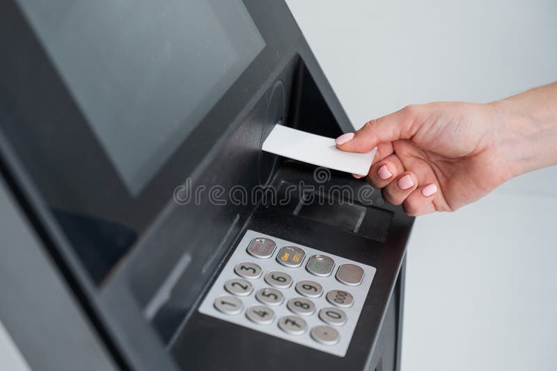 A Faceless Woman Inserts a Credit Card into an ATM. Close-up of a Woman ...