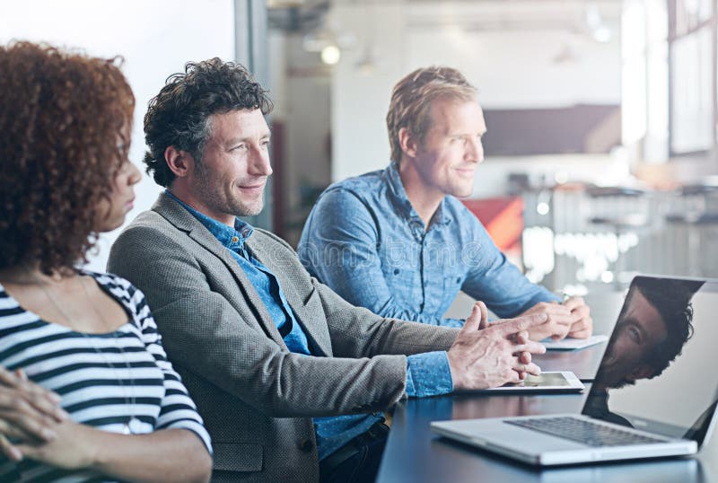 The Faces of a Successful Business. Office Workers Sitting at a ... The Faces of a Successful Business. Office Workers Sitting at a ...