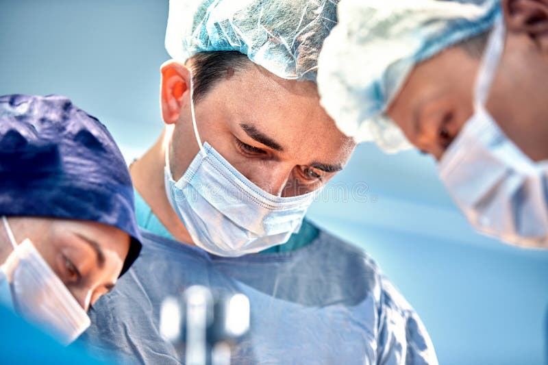 Close-up View of Surgeons Faces in Medical Masks during a Complex and ...