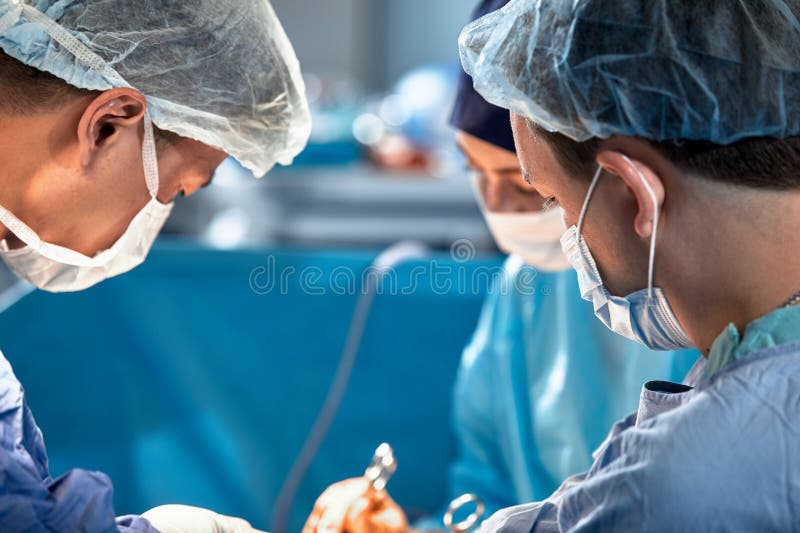 Faces of Surgeons in the Operating Room during the Operation, Modern ...