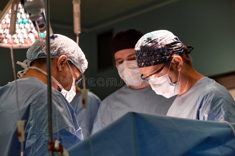 Faces of Surgeons in the Operating Room during the Operation. Modern ...