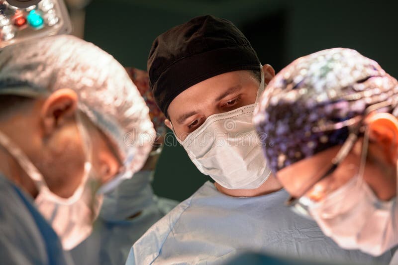 Faces of Surgeons in the Operating Room during the Operation. Modern ...