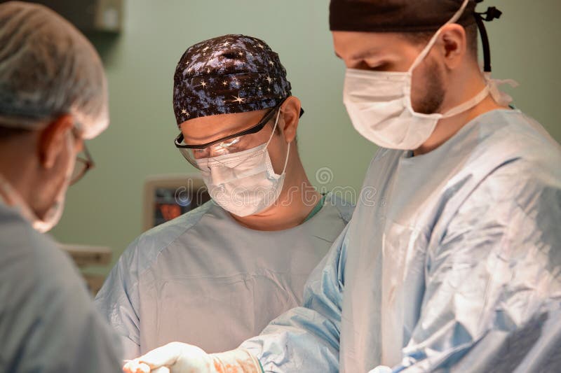 Faces of Surgeons in the Operating Room during the Operation. Modern ...
