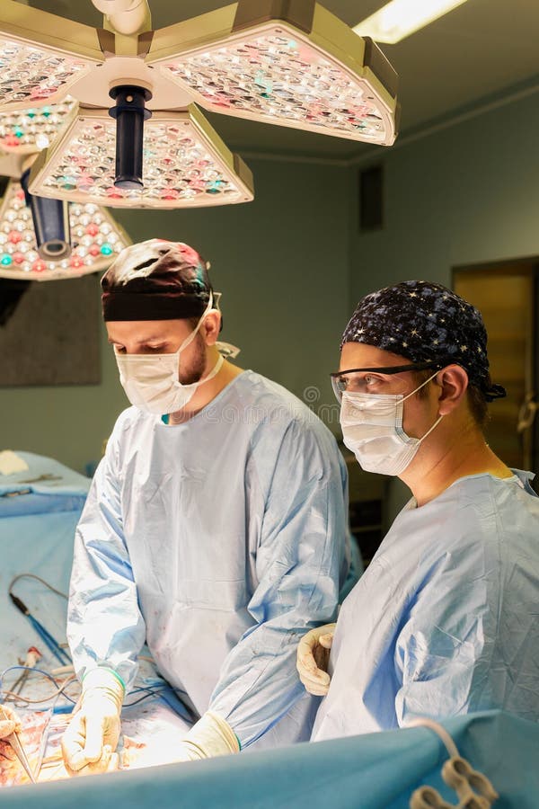 Medical Workers Walk Along a Hospital Corridor. Doctors and Healthcare ...