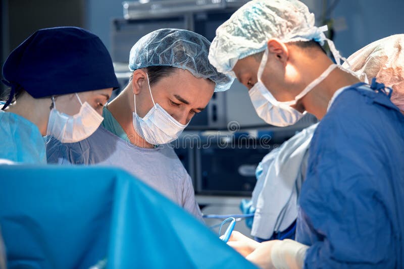 Faces of Surgeons in the Operating Room during the Operation. Modern ...