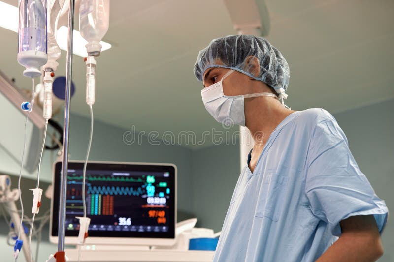 Faces of Surgeons in the Operating Room during the Operation. Modern ...