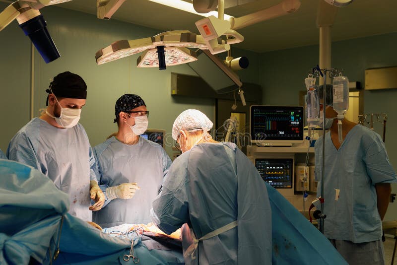 Faces of Surgeons in the Operating Room during the Operation. Modern ...