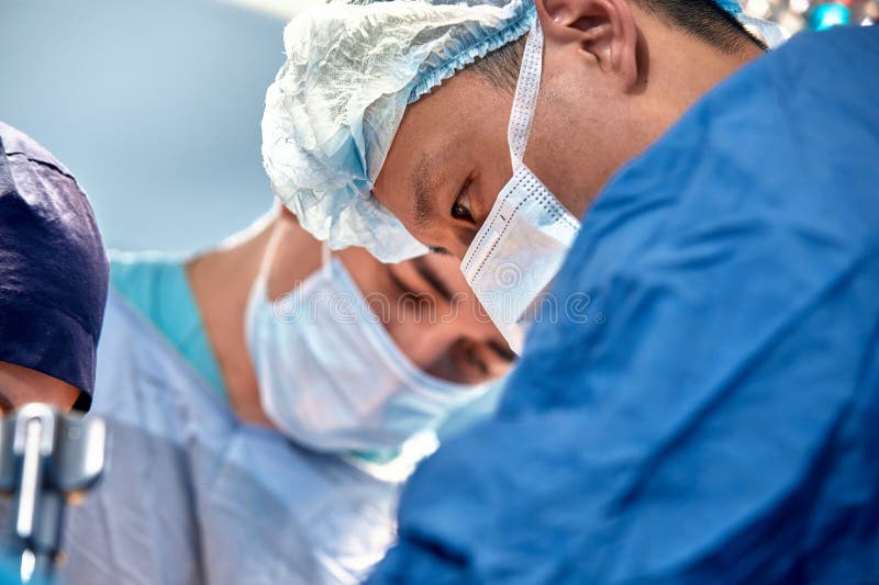 Faces of Surgeons in the Operating Room during the Operation. Modern ...