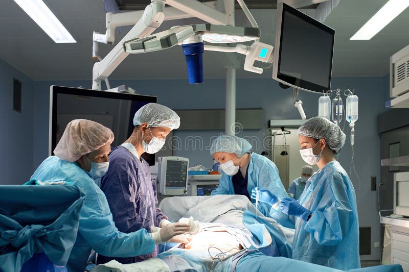Faces of Surgeons in the Operating Room during the Operation. Modern ...