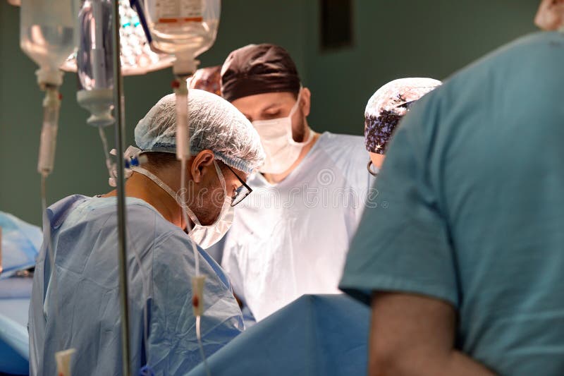 Faces of Surgeons in the Operating Room during the Operation. Modern ...