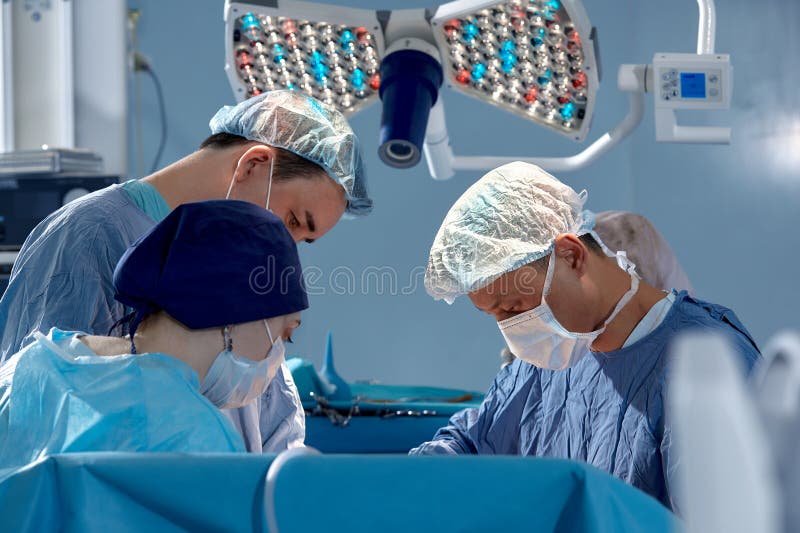 Faces of Surgeons in the Operating Room during the Operation. Modern ...
