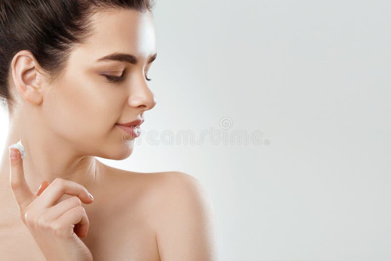 Facial Care Female Applying Cream And Smiling Beauty Face Portrait