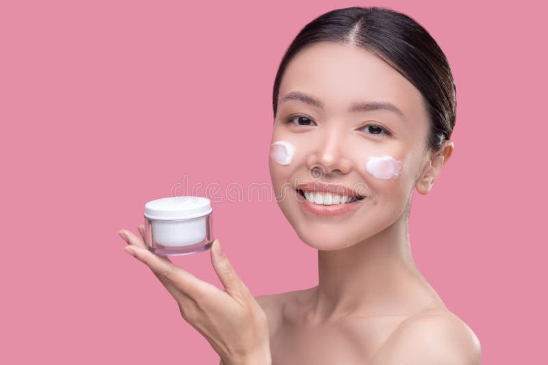 Young Woman Holding a Pack of Face Cream Stock Photo - Image of ...