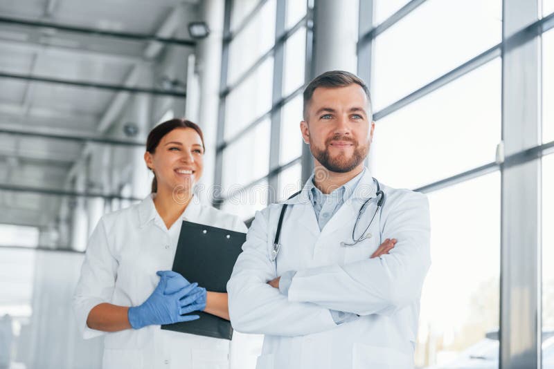 Facial Expressions. Two Doctors in White Coats is in the Clinic Working ...