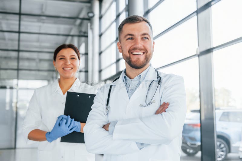 Facial Expressions. Two Doctors in White Coats is in the Clinic Working ...