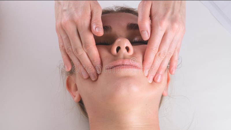 Facial Massage Beauty Treatment Close Up Of A Young Womans Face Lying