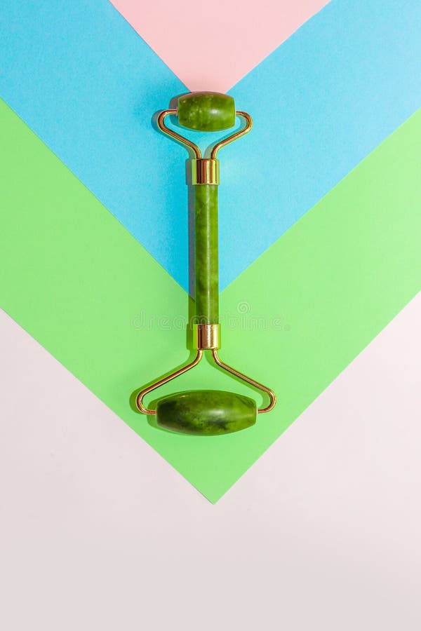 Facial Massage Jade Roller on Abstract Paper Background. Stock Photo ...