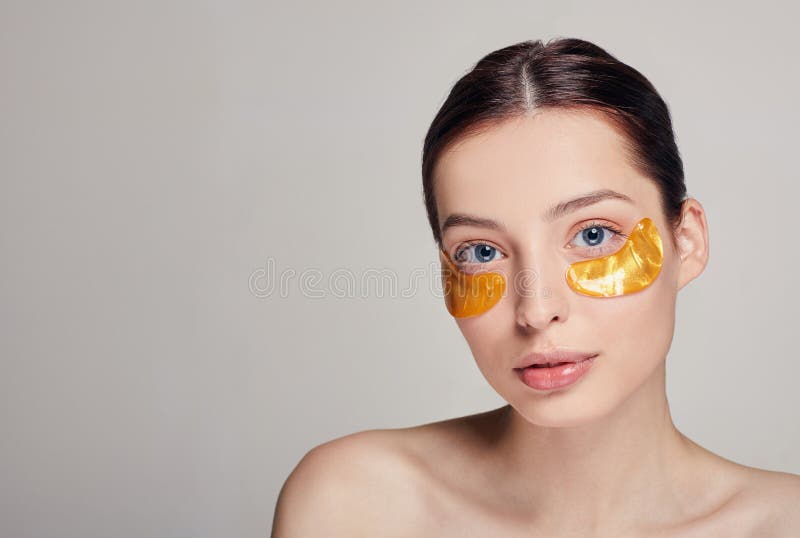 Girl Applying Golden Collagen Patches Under The Eyes Remove Wrinkles