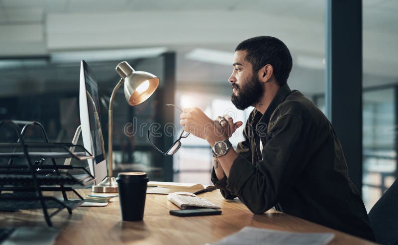 Facing Any Work Challenge Head on. a Young Businessman Using a Computer ...