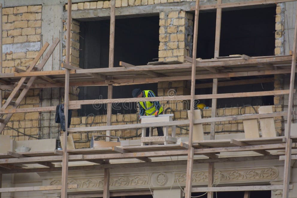 Facing of Facade of the Building, Workers-builders Editorial ...
