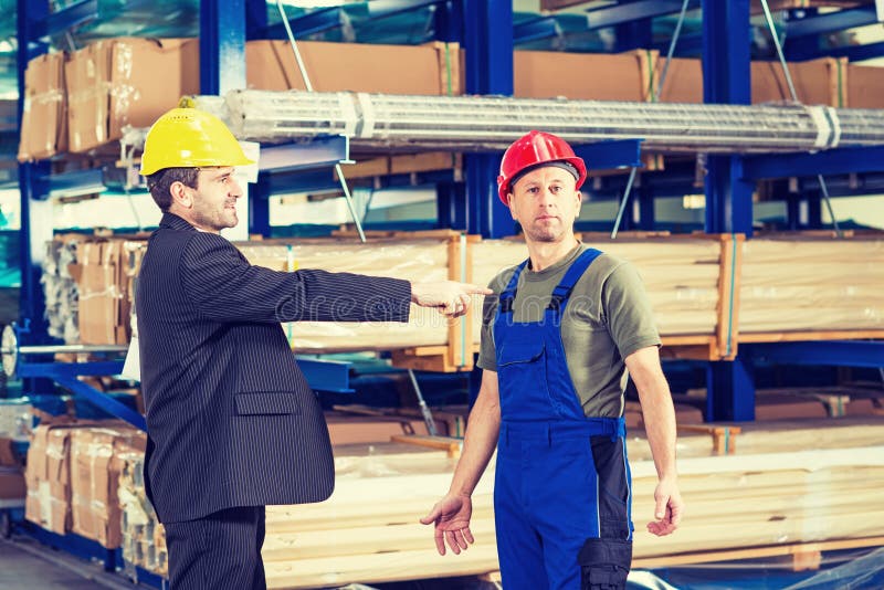 Boss Pointing at Worker in Factory Stock Photo - Image of point ...