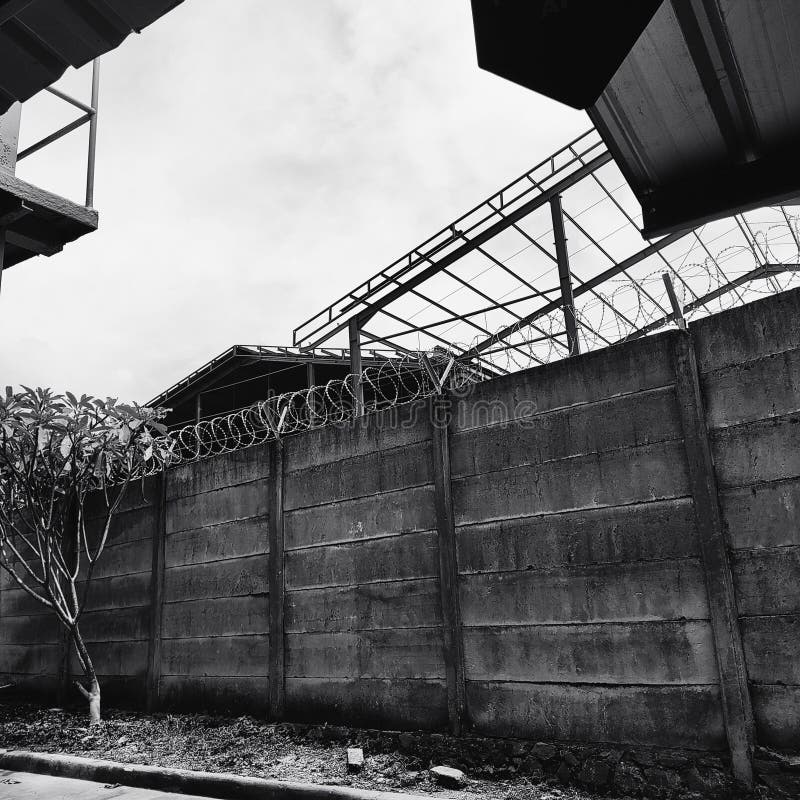 A Factory Building Behind a Large Wall Stock Image - Image of factory ...
