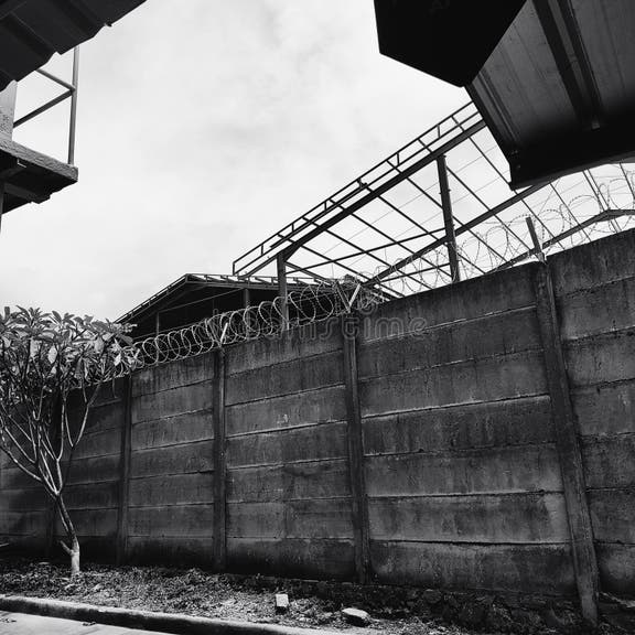 A Factory Building Behind a Large Wall Stock Image - Image of factory ...