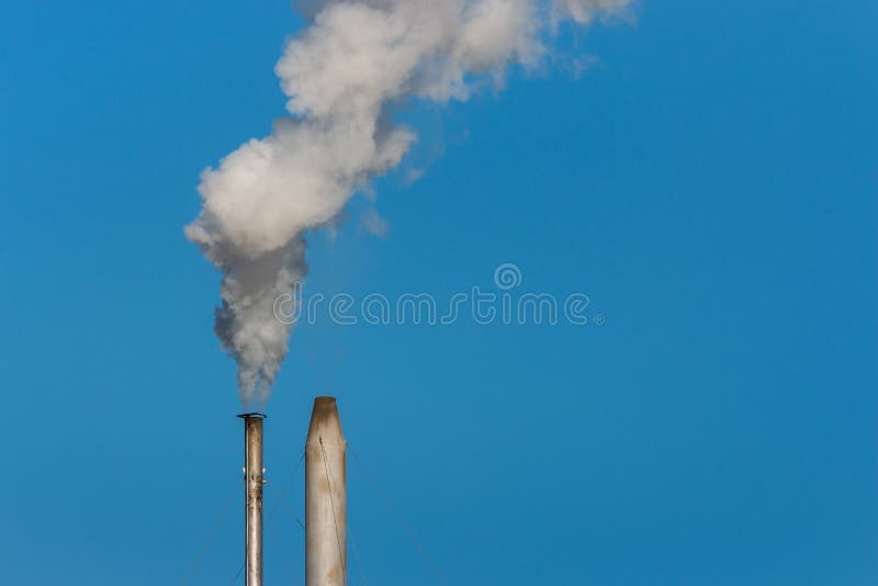 Factory Chimneys with Smoke Against Blue Sky Stock Image - Image of ...