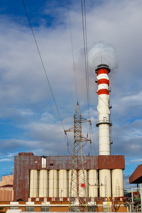 Factory Chimney and Abandoned Warehouse Against Blue Sky Stock Photo ...