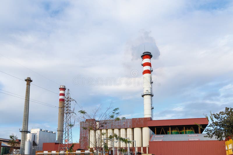 Factory Chimney And Abandoned Warehouse Against Blue Sky Stock Photo ...