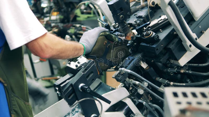 Factory Employee is Loading a Boot into an Adjustment Mechanism Stock ...