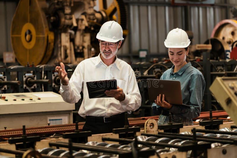 Factory Engineer with Assistant Using Laptop Inspect Factory ...