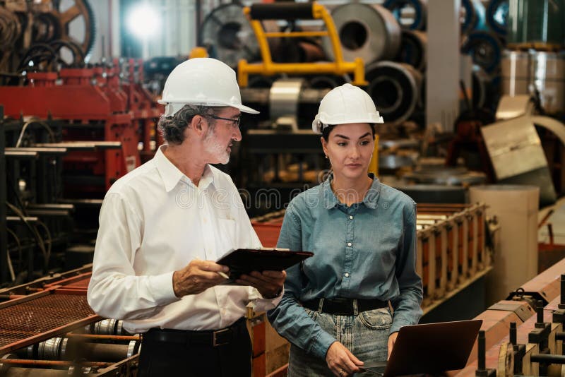 Factory Engineer with Assistant Using Laptop Inspect Factory ...