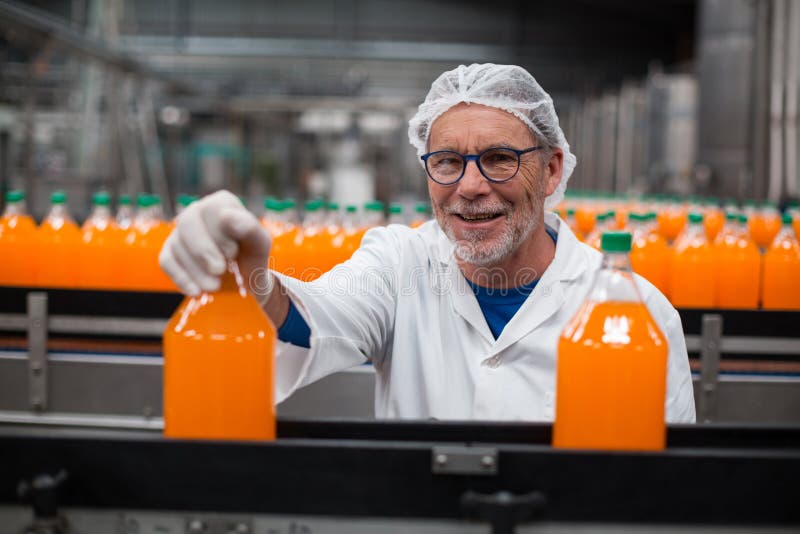 Factory Engineer Examining a Bottle of Juice Stock Photo - Image of ...