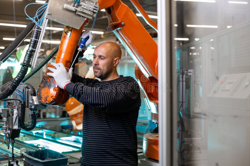 Factory Engineer Operating with Automatic Robot Arms in Automotive ...