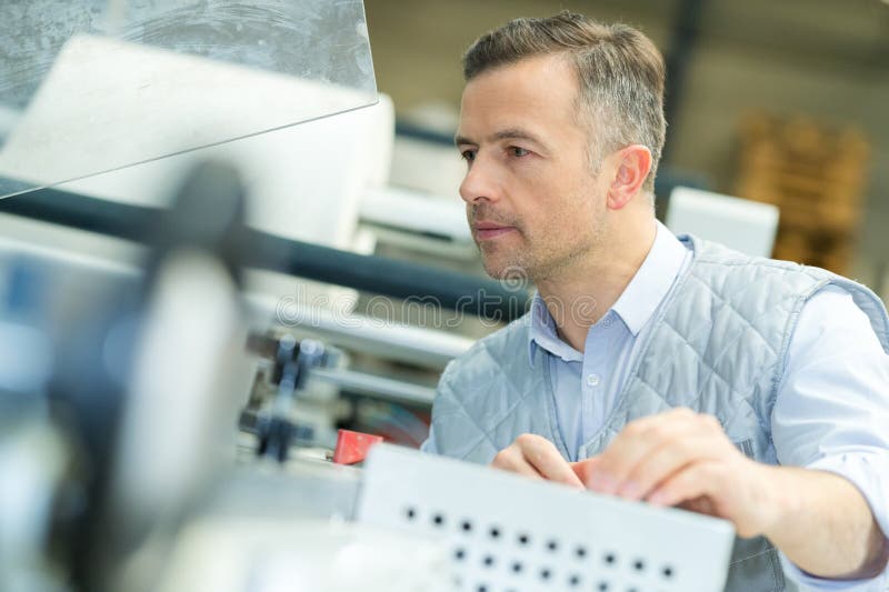 Factory Engineer Operating Machine Stock Image - Image of building ...