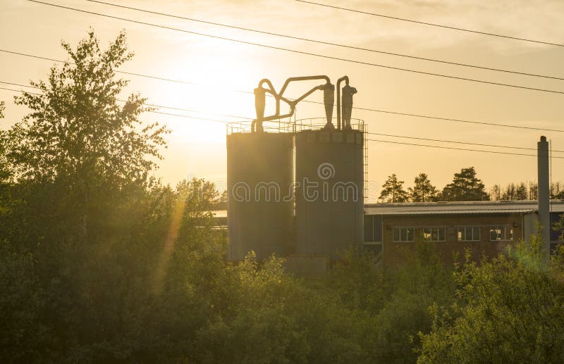 Factory in the Field. Two Large Tanks and a Pipe from Which Smoke Comes ...