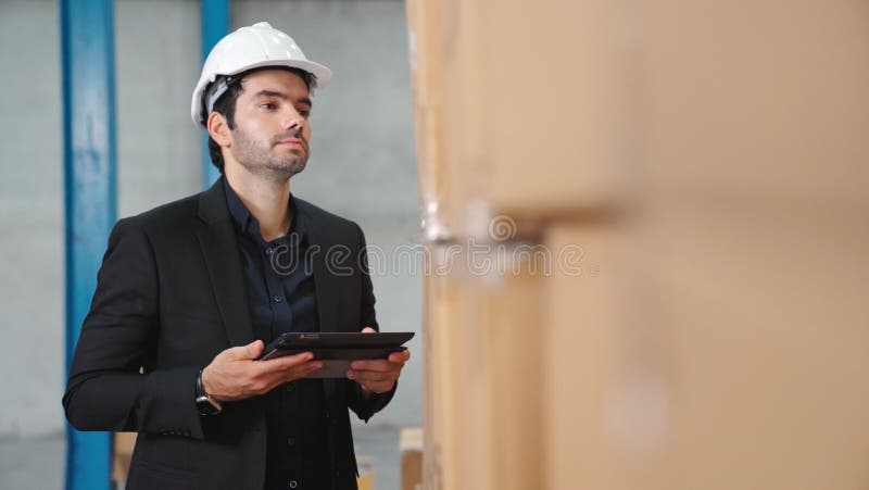 Factory Manager Using Tablet Computer in Warehouse or Factory Stock ...
